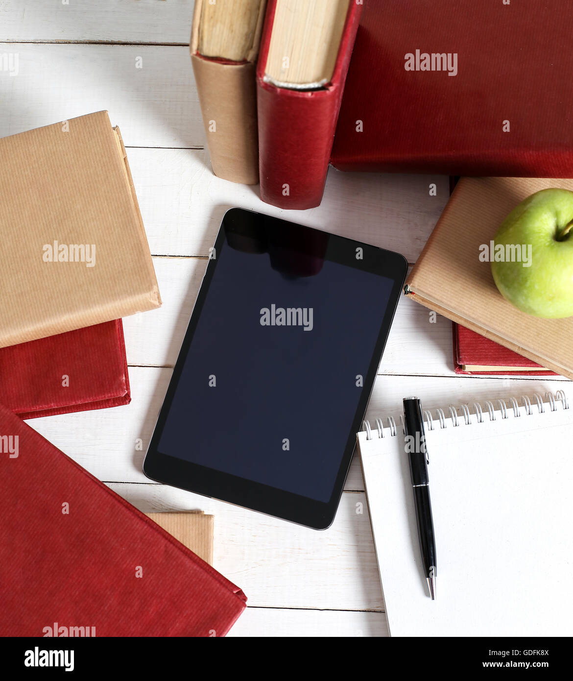 Books with tablet Stock Photo - Alamy