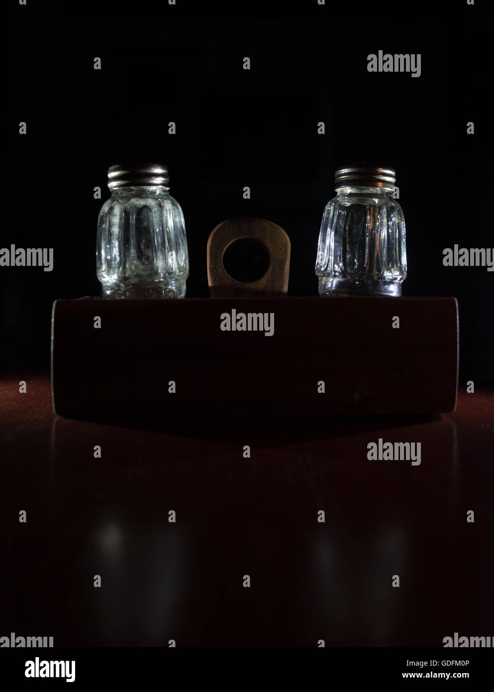 Empty salt bottles on wooden holder Stock Photo - Alamy