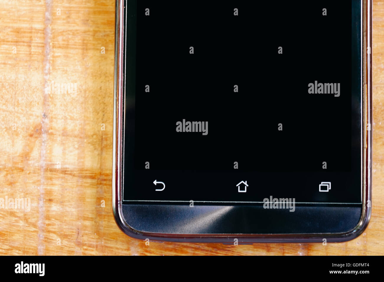 mobile phone on a hardwood desk and blank copy space, close-up, top ...