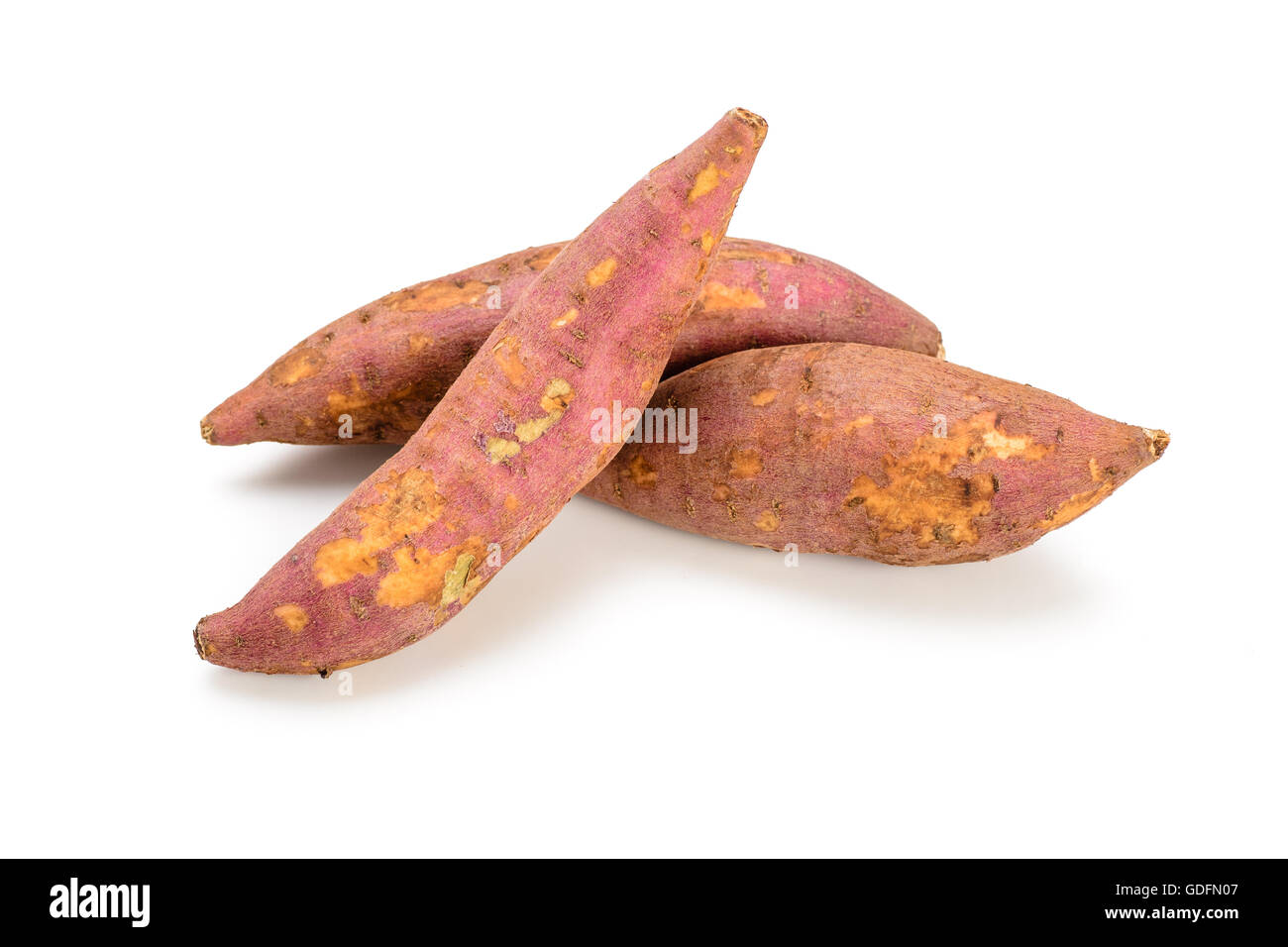 red sweet potatoes on the white background Stock Photo - Alamy