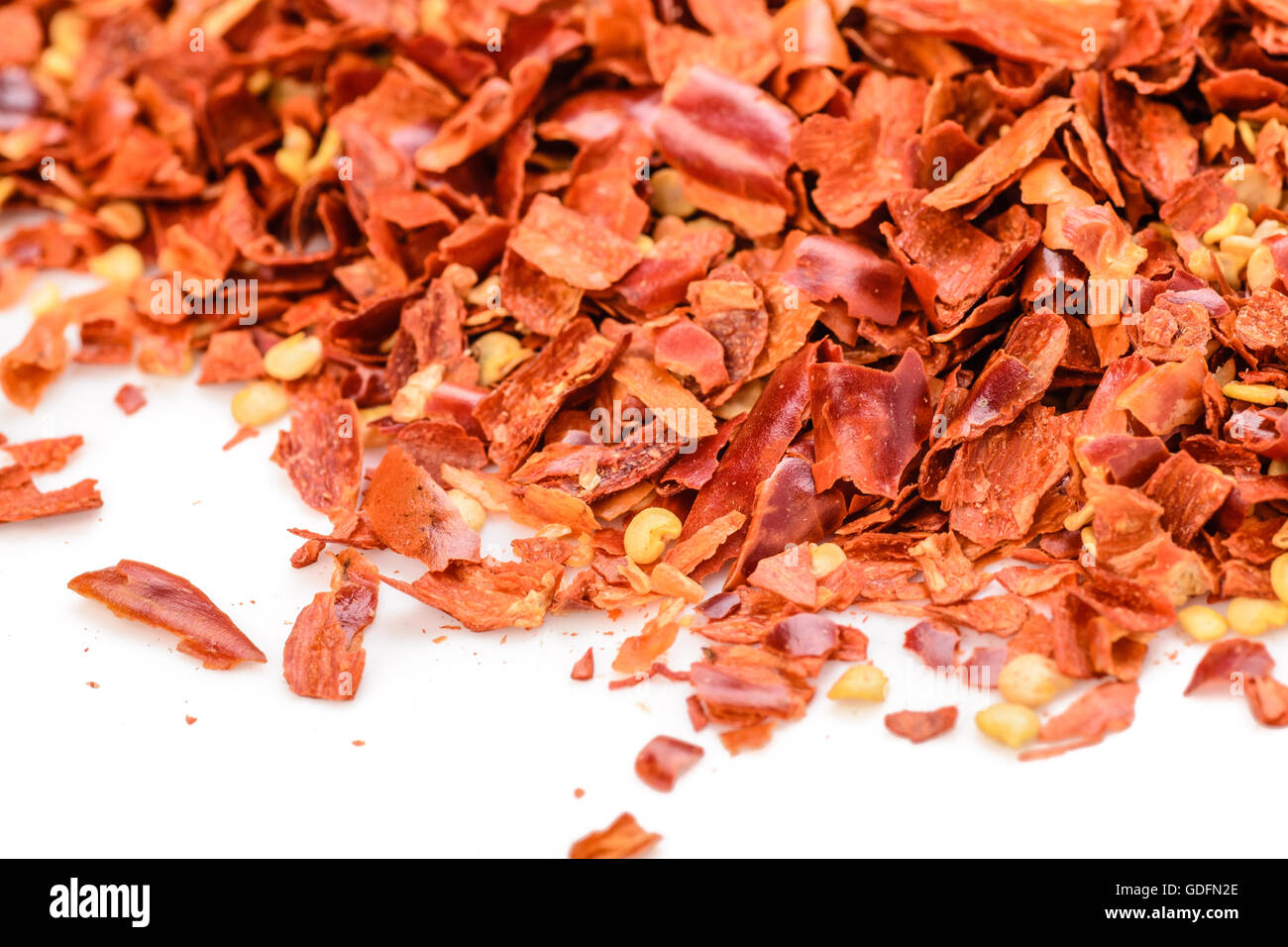 red chilli flakes on the white background Stock Photo - Alamy