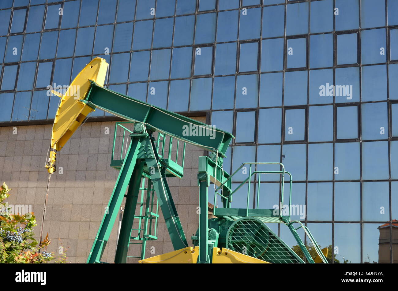 Old oil pump in front of business building Stock Photo - Alamy