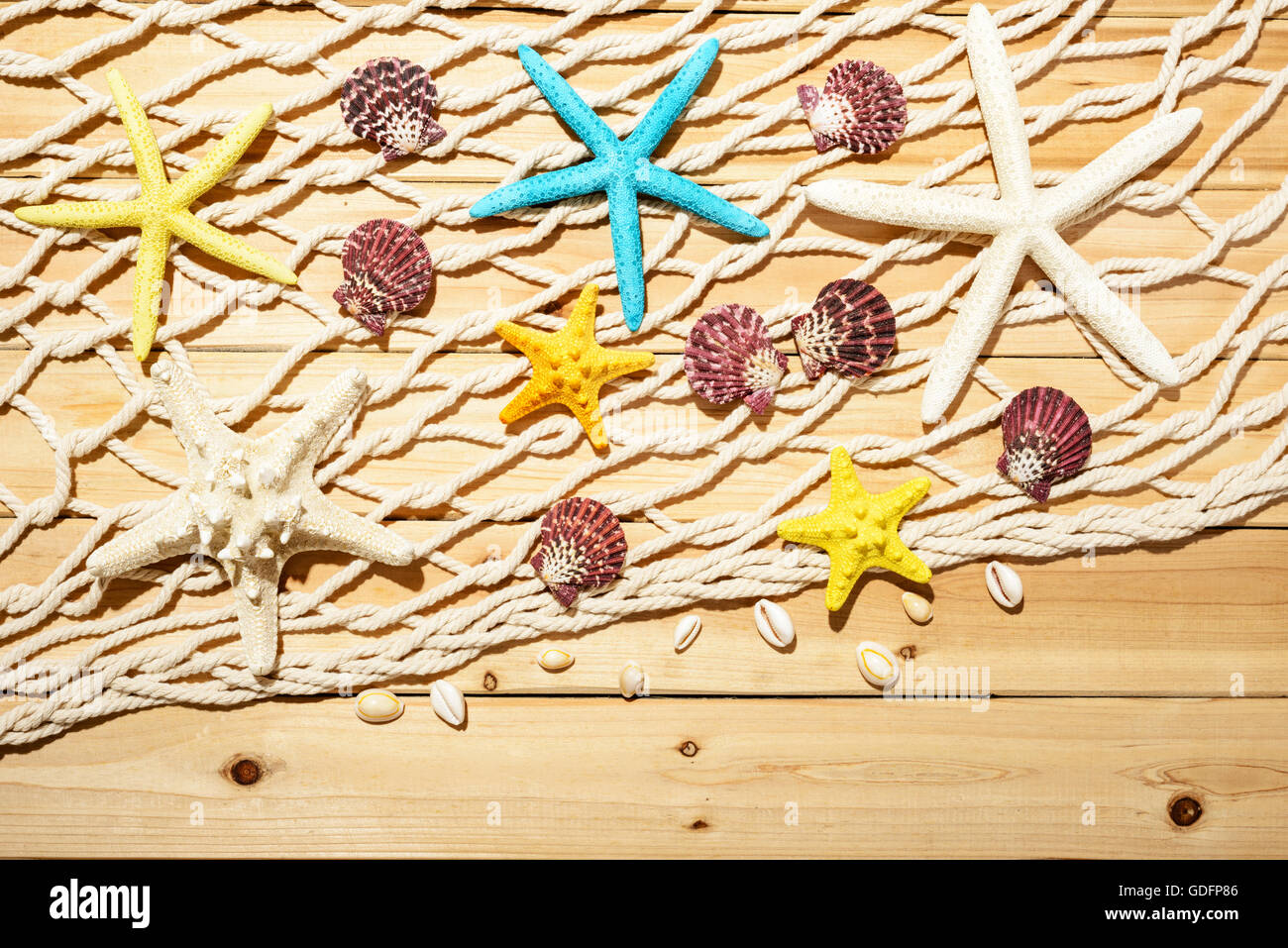 seashell, starfish and fishing net on the wooden board Stock Photo - Alamy