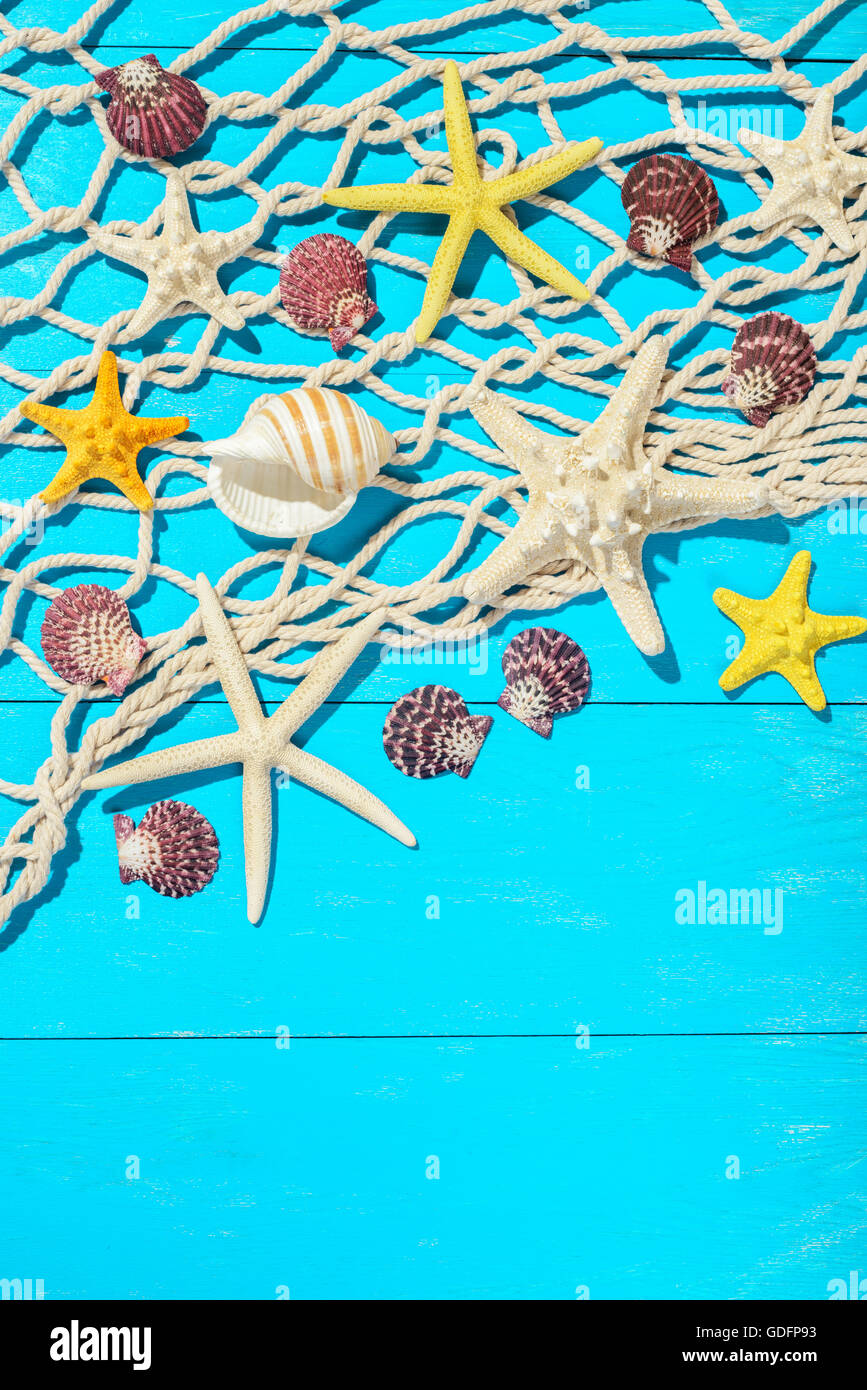 fishing net and seashells on the blue wooden board Stock Photo - Alamy