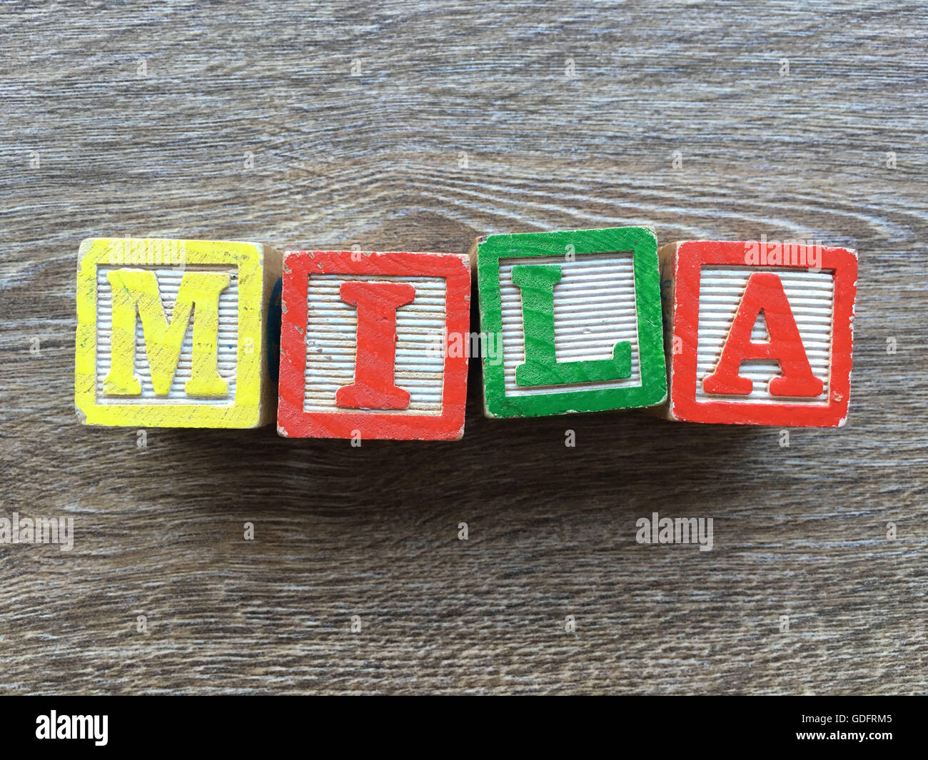 Mila name written with wood block letter toys Stock Photo - Alamy