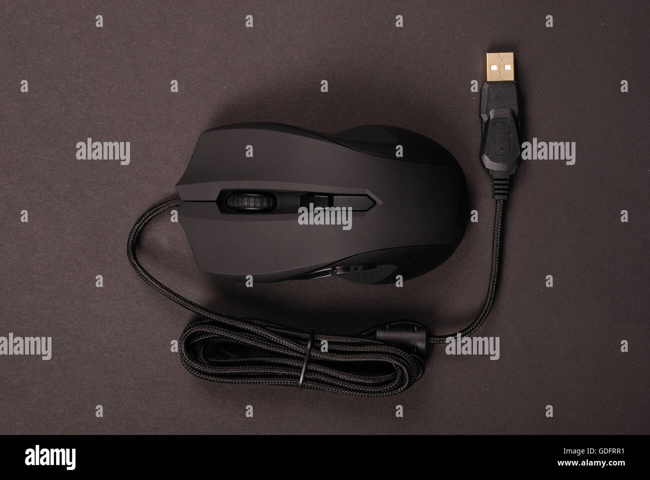 Black computer optical mouse isolated on black background with soft ...