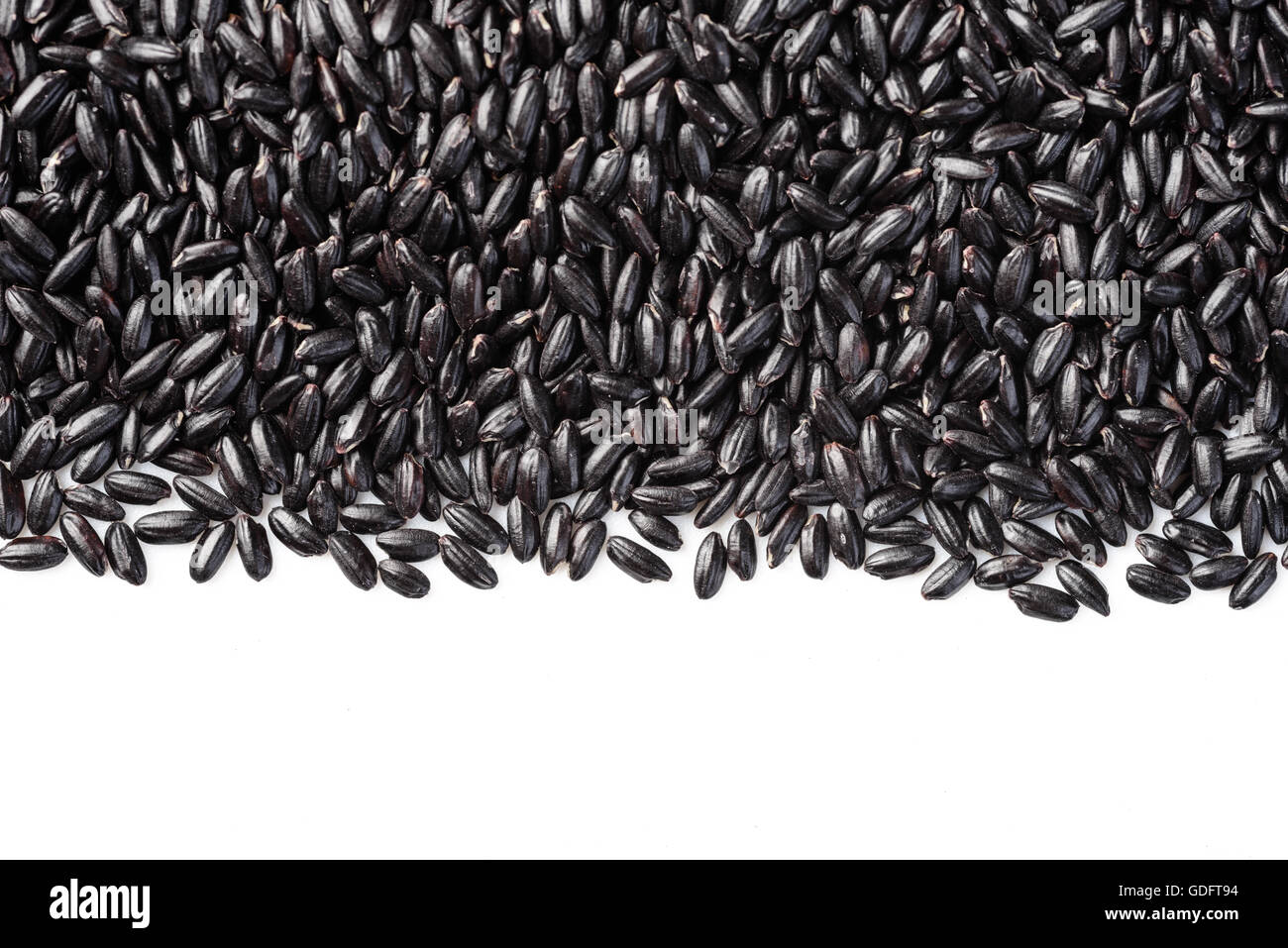 black rice on the white background Stock Photo - Alamy