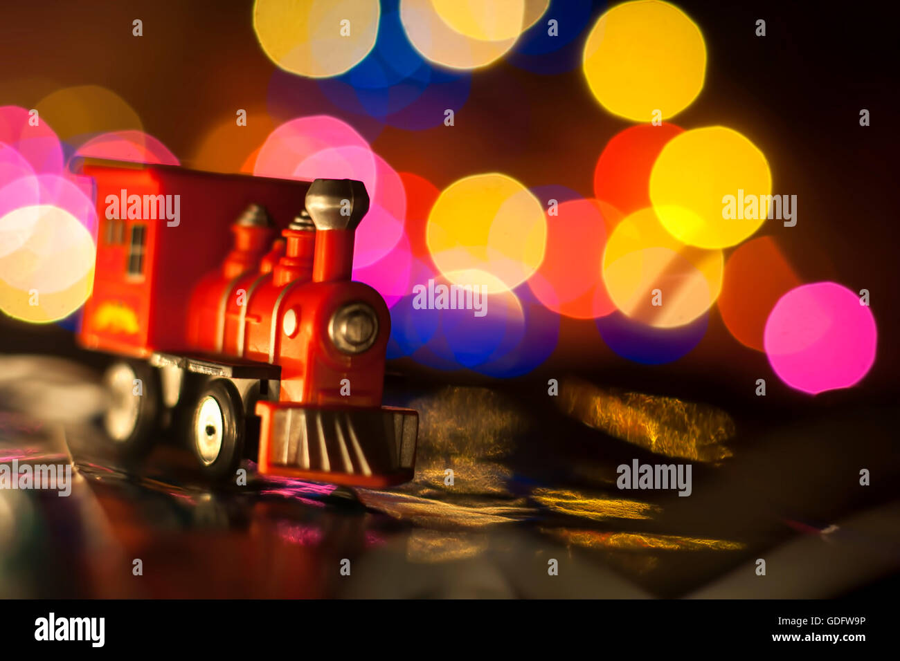 Christmas lights and a toy train engine Stock Photo - Alamy