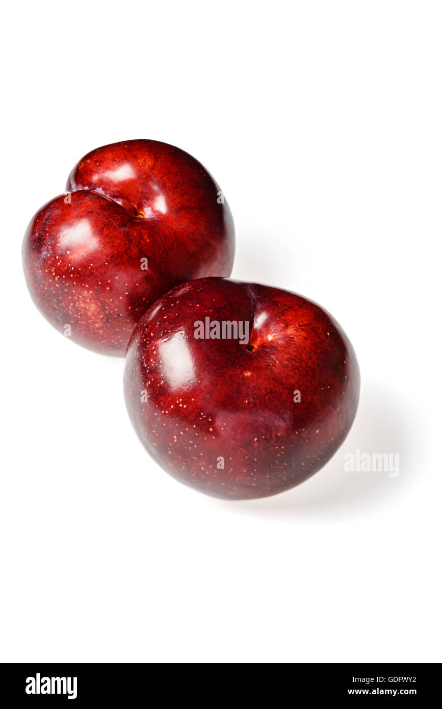 fresh red plums on white, top view Stock Photo - Alamy