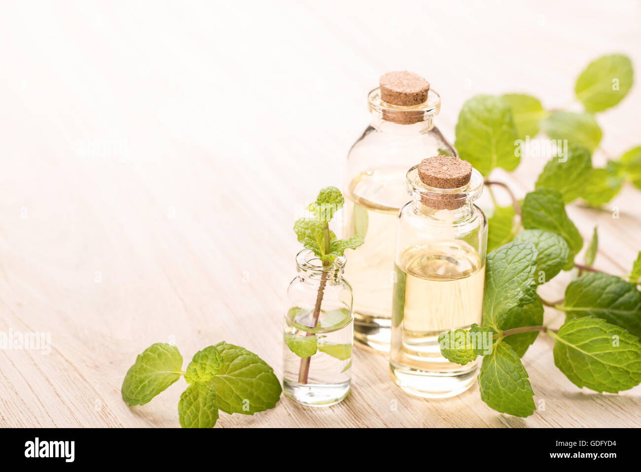fresh mint oil on wooden table Stock Photo - Alamy