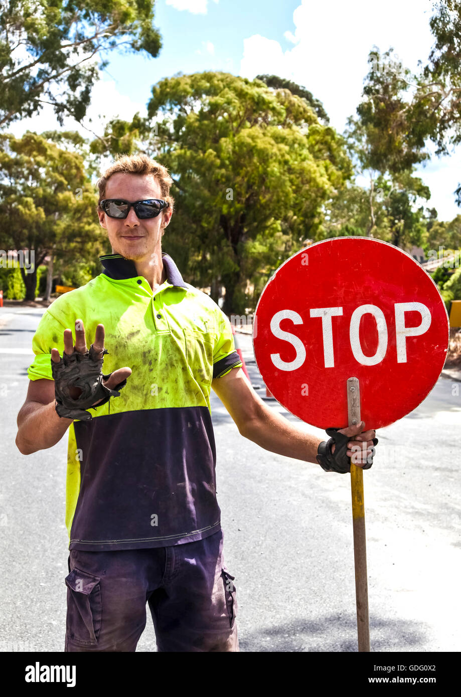 Road worker controls traffic flow Stock Photo - Alamy