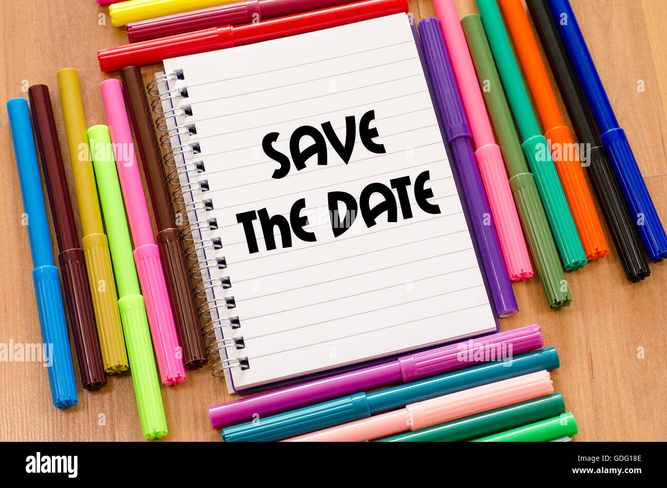 Save the date written on notebook over wooden background Stock Photo ...