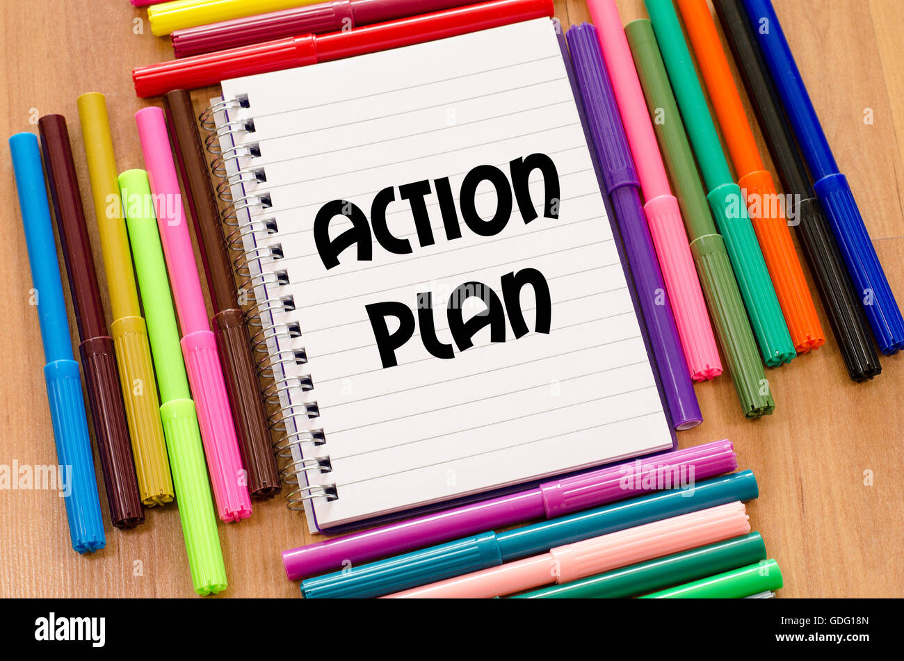 Action plan written on notebook over wooden background Stock Photo - Alamy