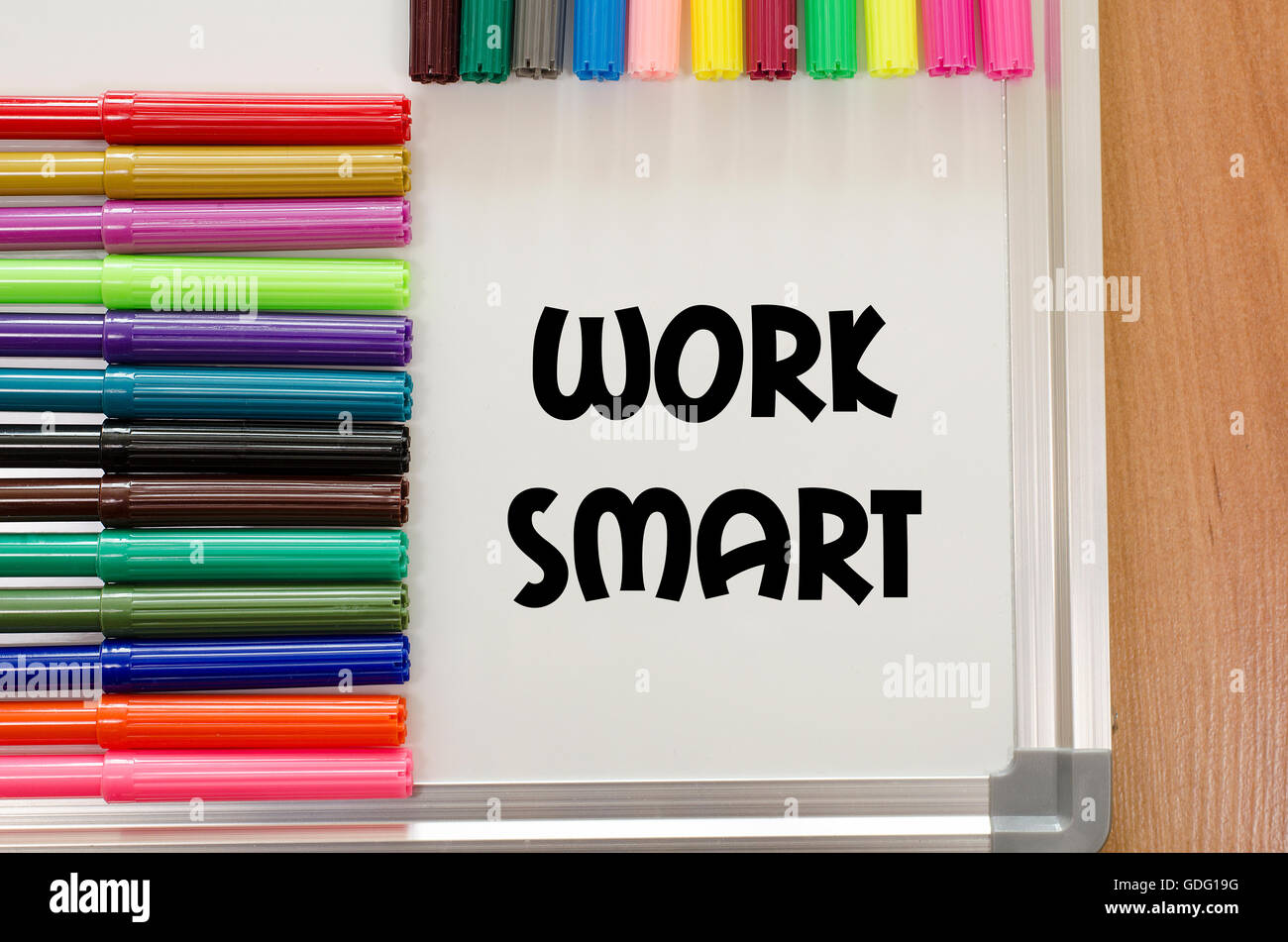 Work smart written on whiteboard over wooden background Stock Photo - Alamy
