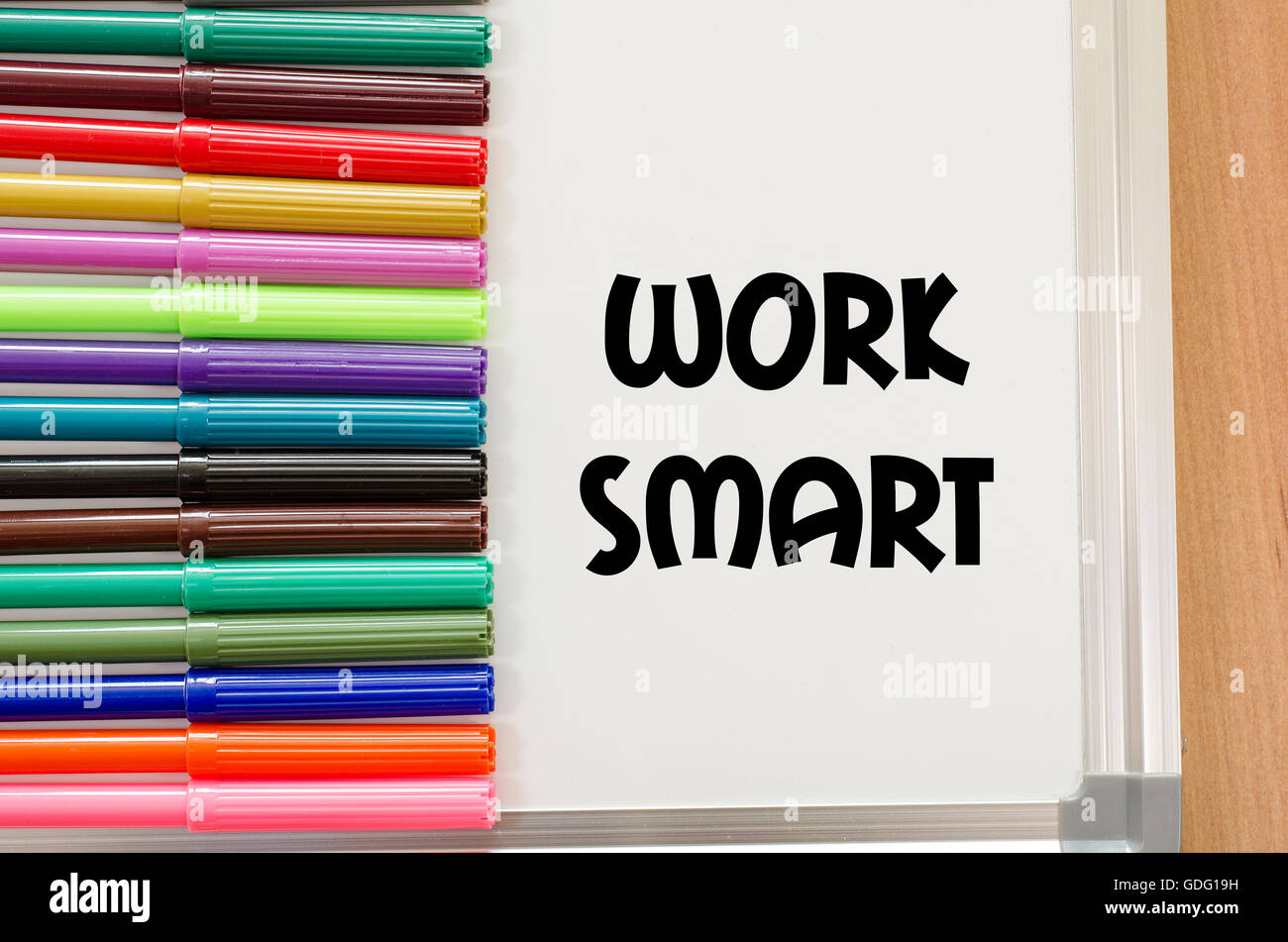 Work smart written on whiteboard over wooden background Stock Photo - Alamy