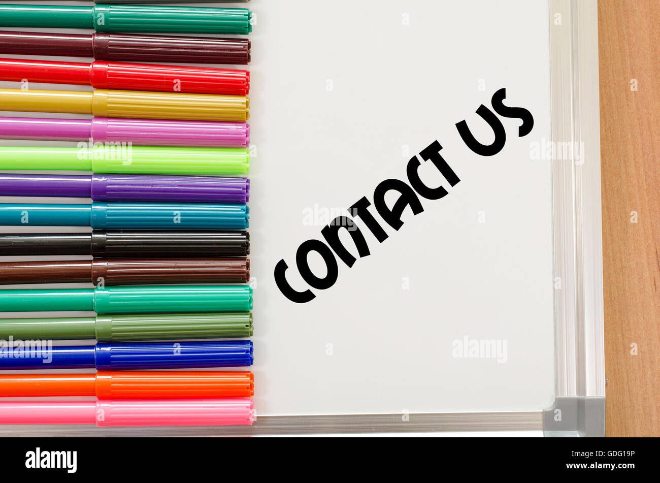 Contact us written on whiteboard over wooden background Stock Photo - Alamy