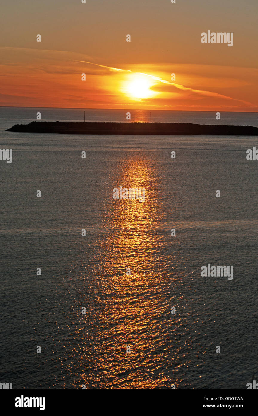 Iceland, Europe: sunset on an inlet of the harbour of Husavik, a ...