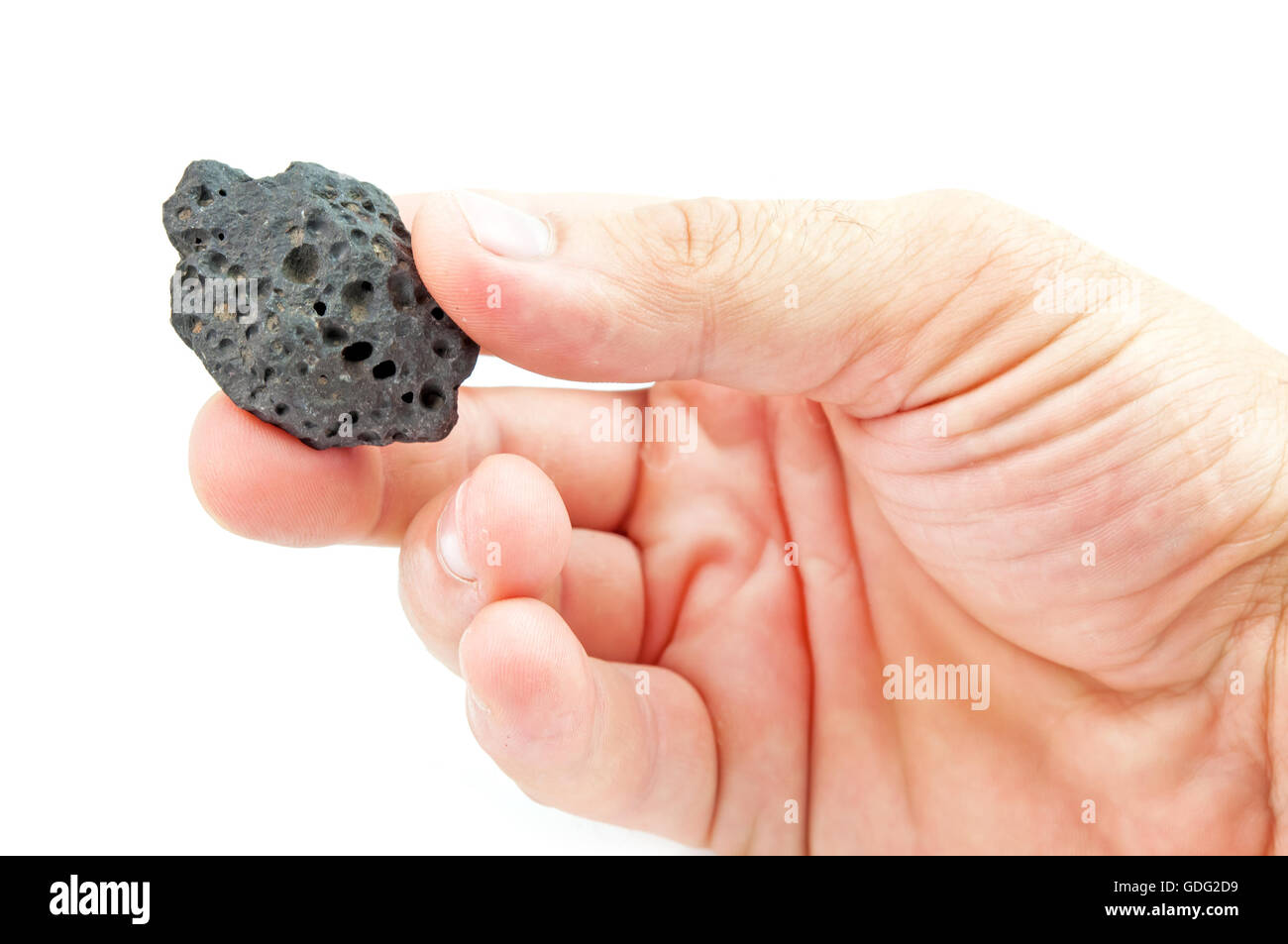 volcanic lava in hand isolated on a white background Stock Photo - Alamy