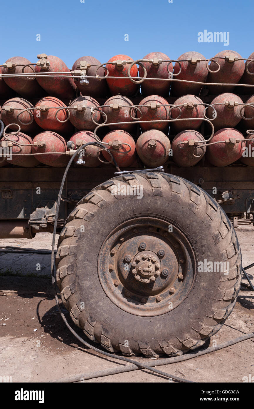 Trailer loaded with red, old and rusty gas tanks Stock Photo - Alamy