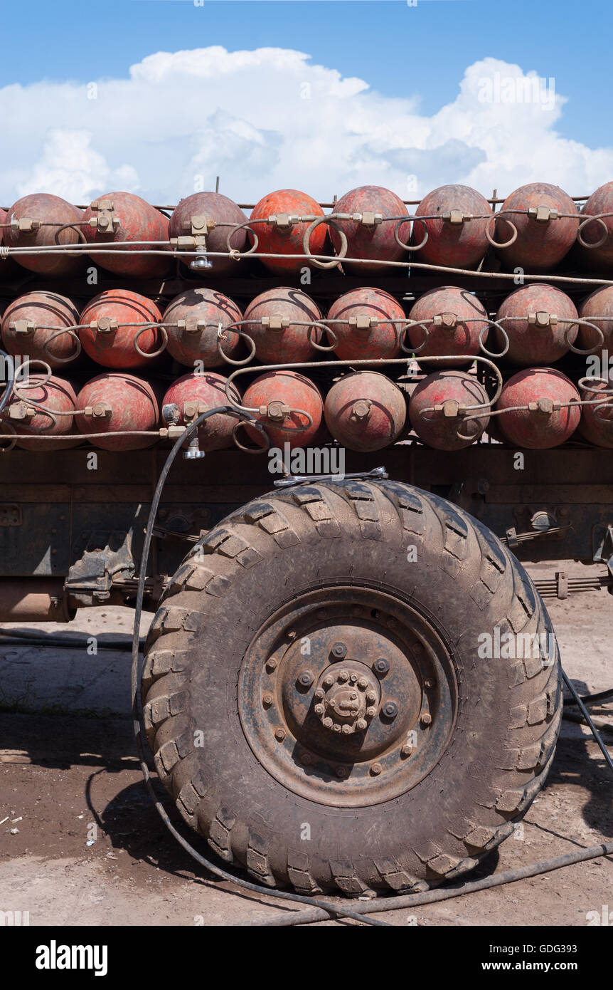 Trailer loaded with red, old and rusty gas tanks Stock Photo - Alamy