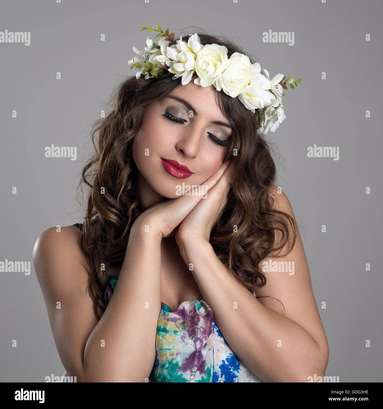 Close up portrait of young female beauty pretends to sleep with head on ...