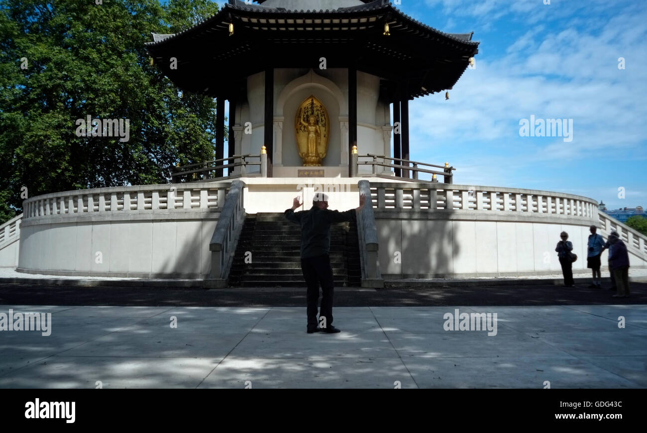 A man exercises in front of the London Peace Pagoda in Battersea Park ...