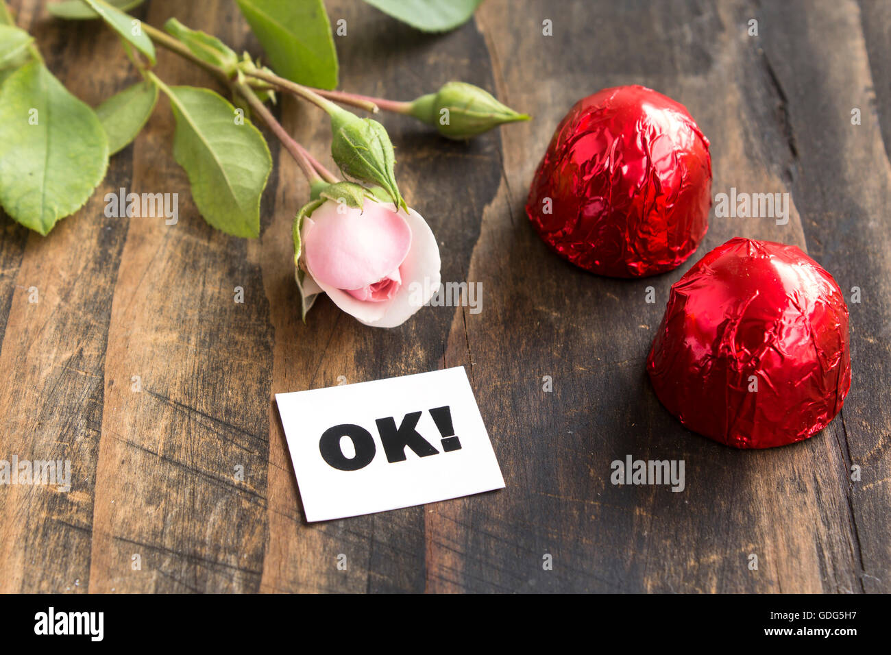 OK Card with Two Pralines and Rose Stock Photo - Alamy