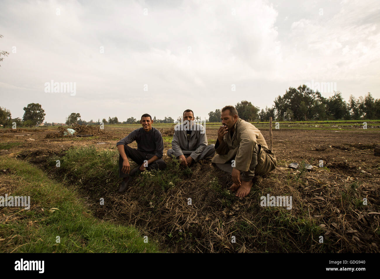 Farmers resting next to their field Stock Photo - Alamy