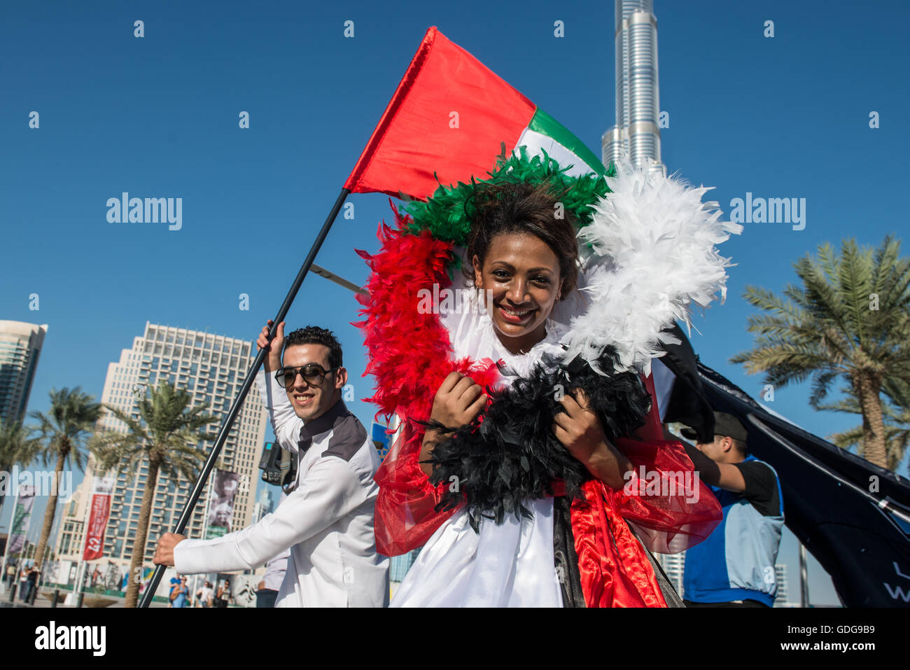 Lady with feather boa in UAE colors, Dubai Stock Photo - Alamy