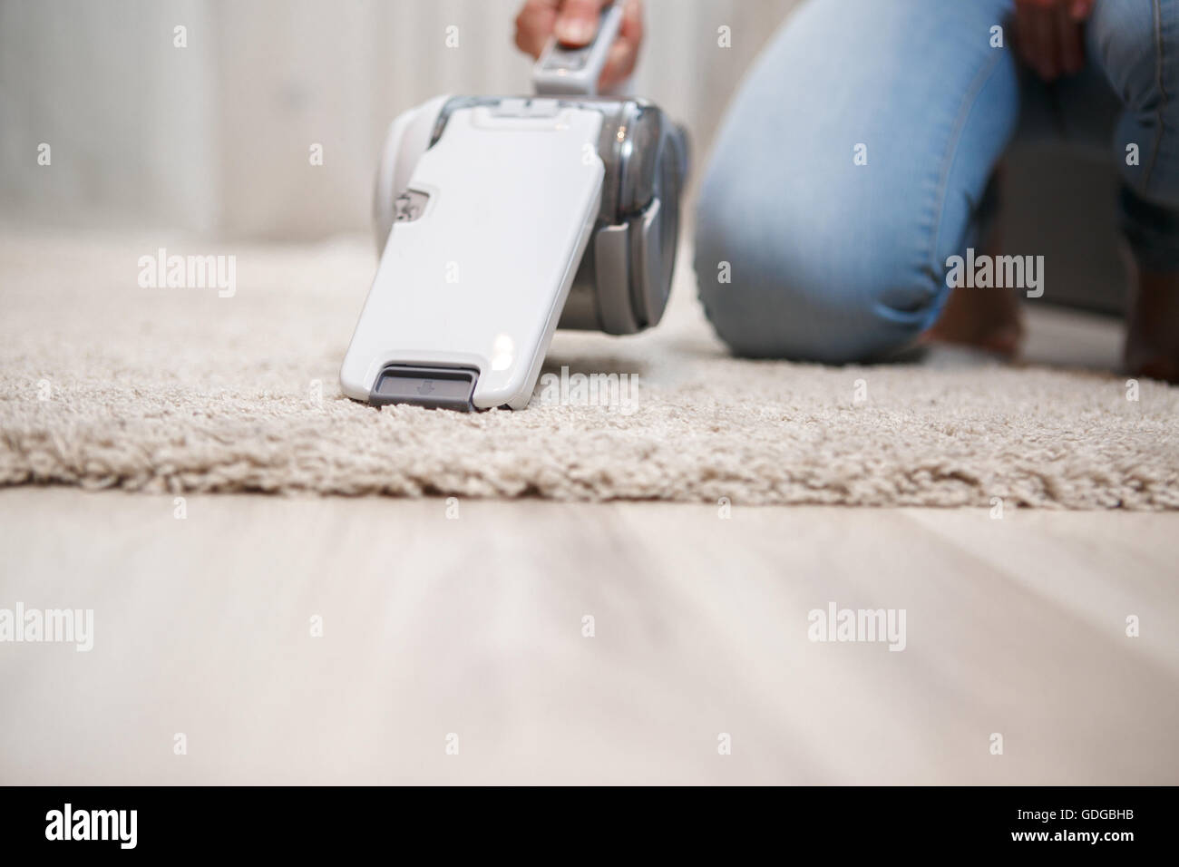 Image of modern house cleaning by cordless handheld vacuum cleaner ...