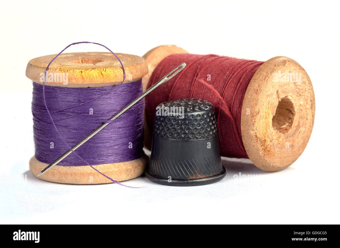 Old thimble and needle with thread on white with shadow Stock Photo - Alamy