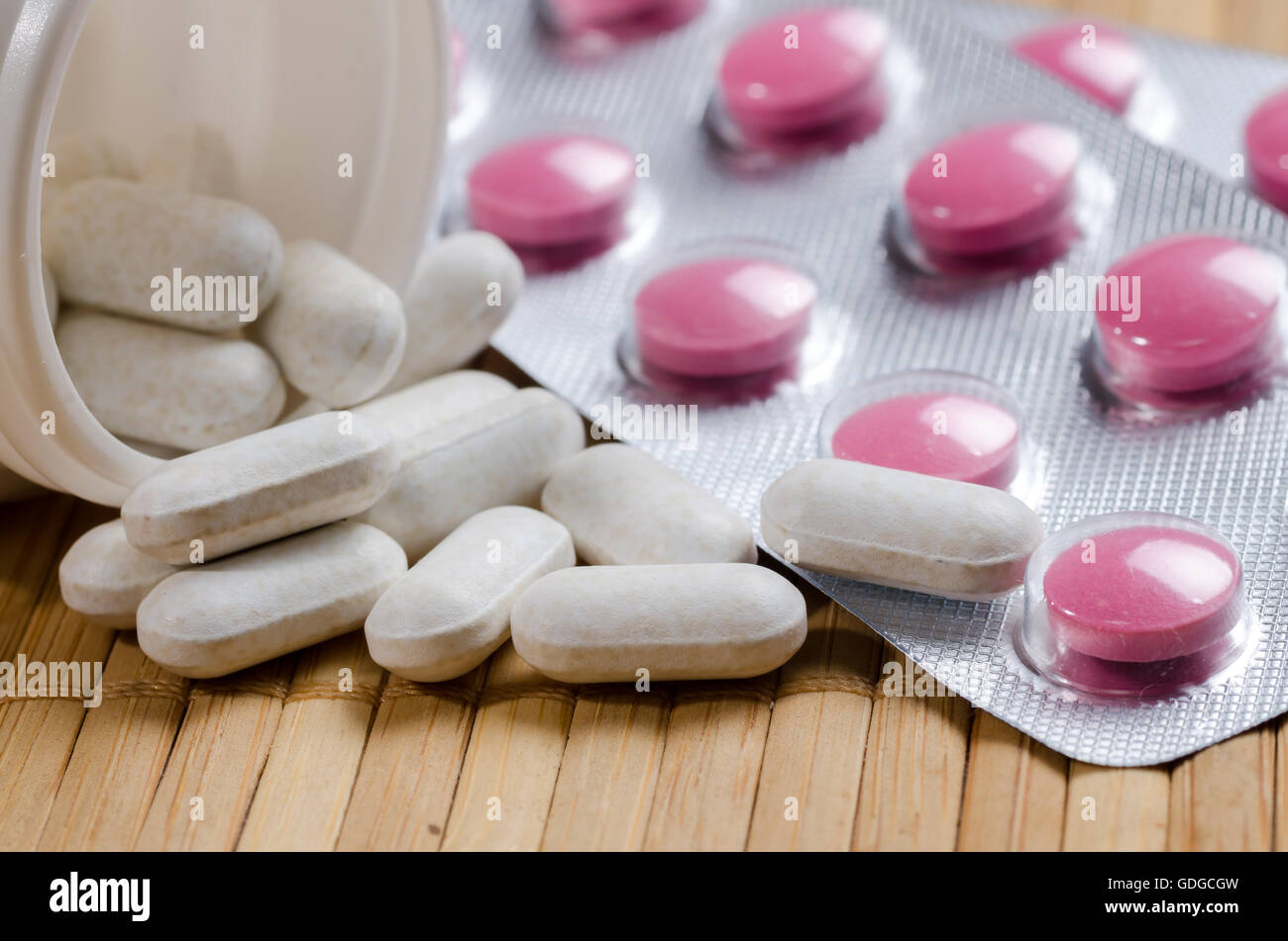 Pills in package and in the bottle close up Stock Photo - Alamy