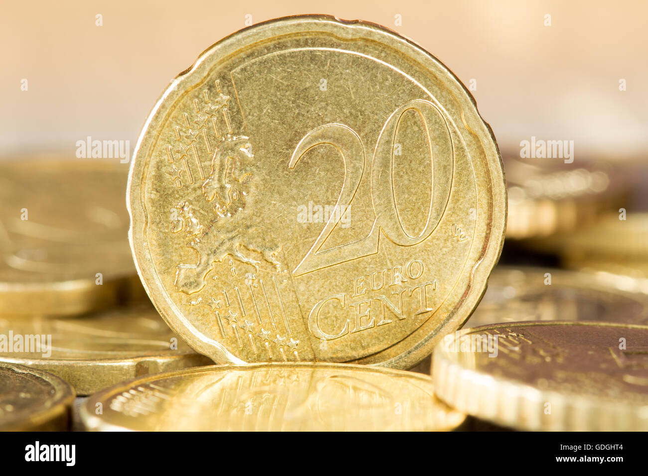 Closeup of a 20 euro cent coin standing between other coins Stock Photo ...