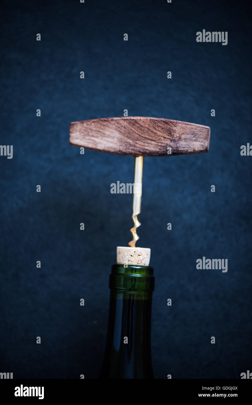 pulling cork from wine bottle, dark slate background Stock Photo - Alamy