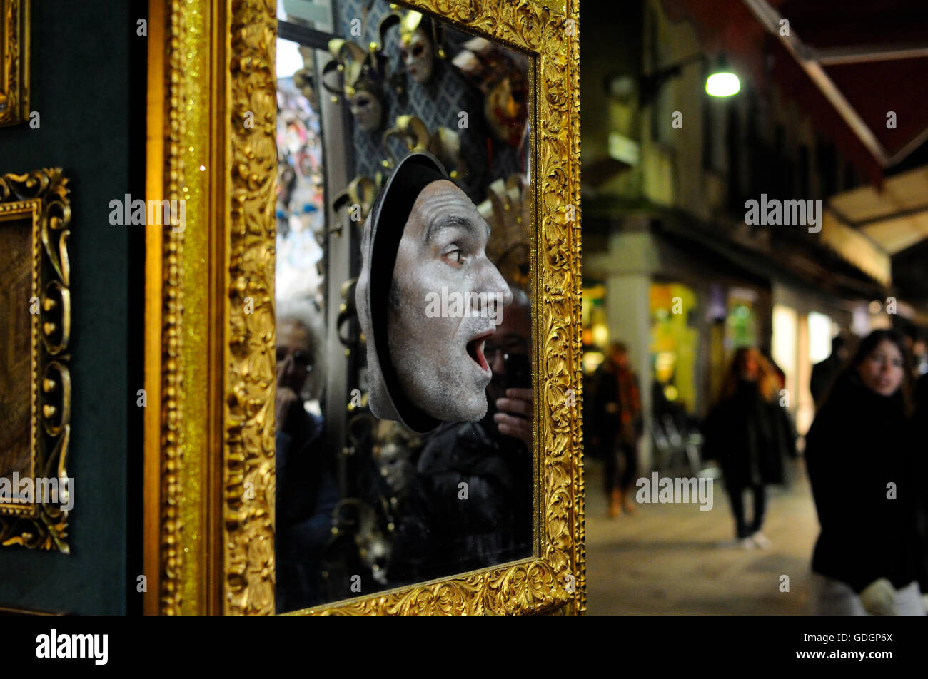 Silver painted man in golden frame mirror during Carnival of Venice ...