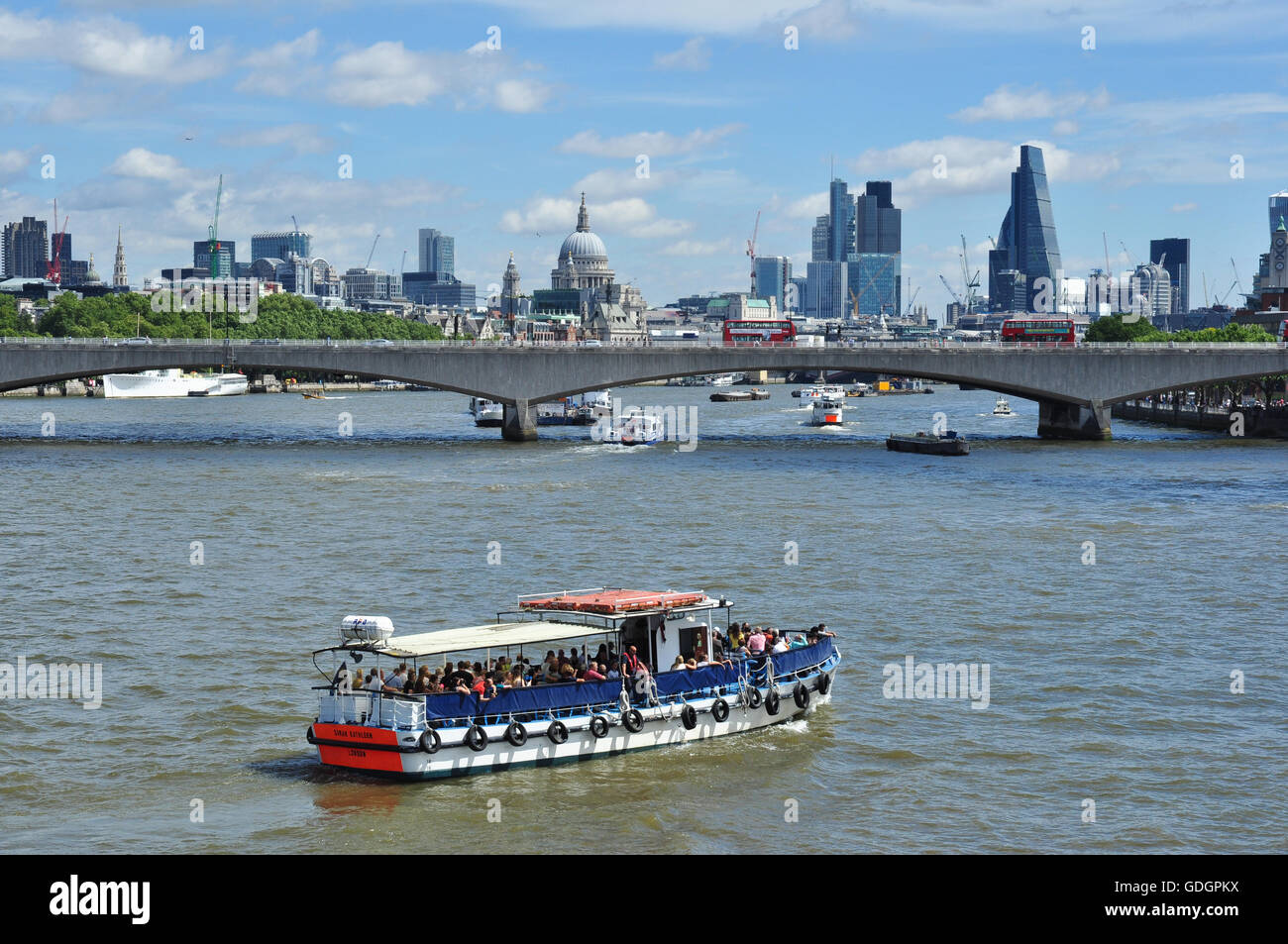 Sightseeing boat, Waterloo bridge and the city skyline, River Thames ...
