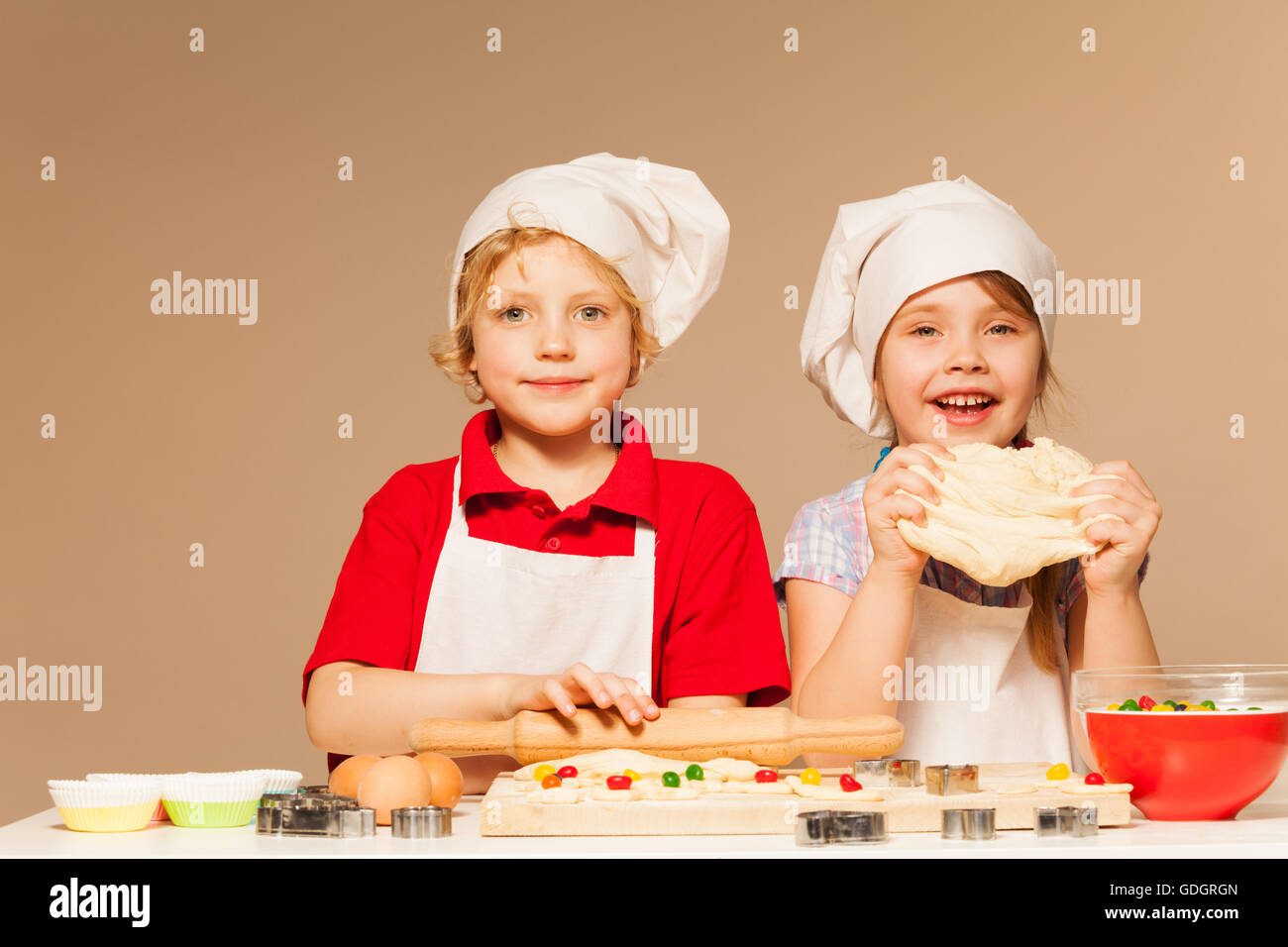 Happy bakers making dough for homemade cookies Stock Photo - Alamy