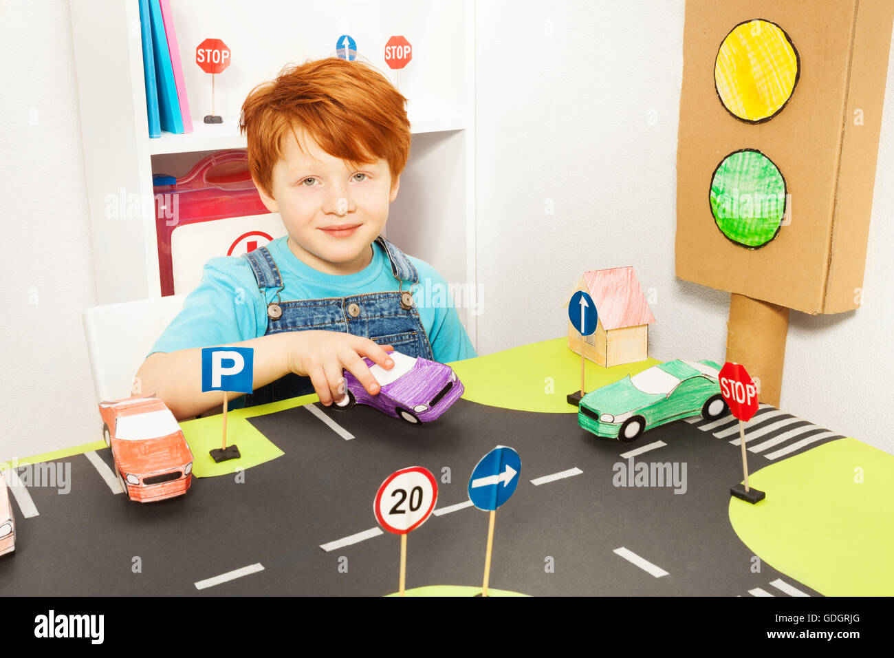 Cute redheaded boy playing driver in kindergarten Stock Photo - Alamy