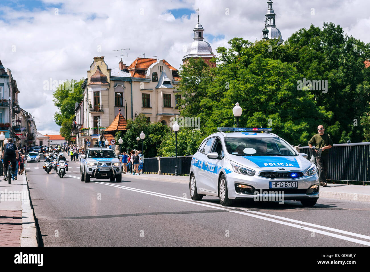 Polish police convoy on a bridge with a view of the old town towers in ...