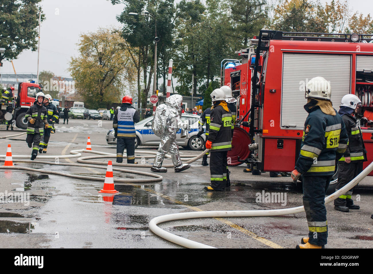 Polish firemen standing beside fire engines watching firefighters Stock ...