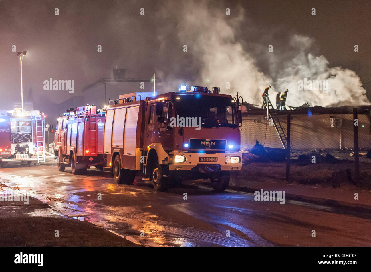 Polish fire engines during fire fighting in the frosty winter night and ...
