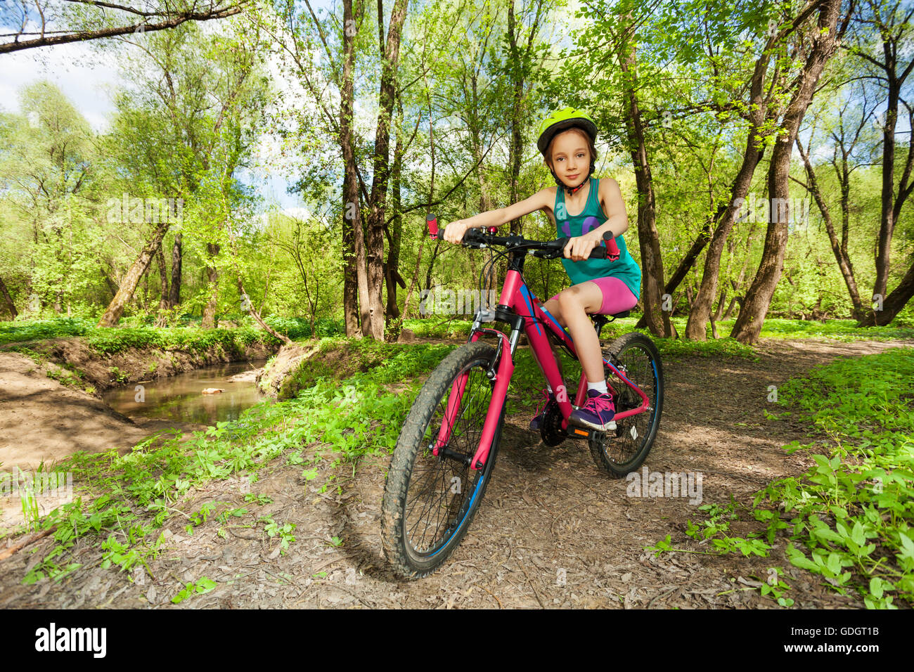 Young girl cycling mountain bike on forest trail Stock Photo - Alamy