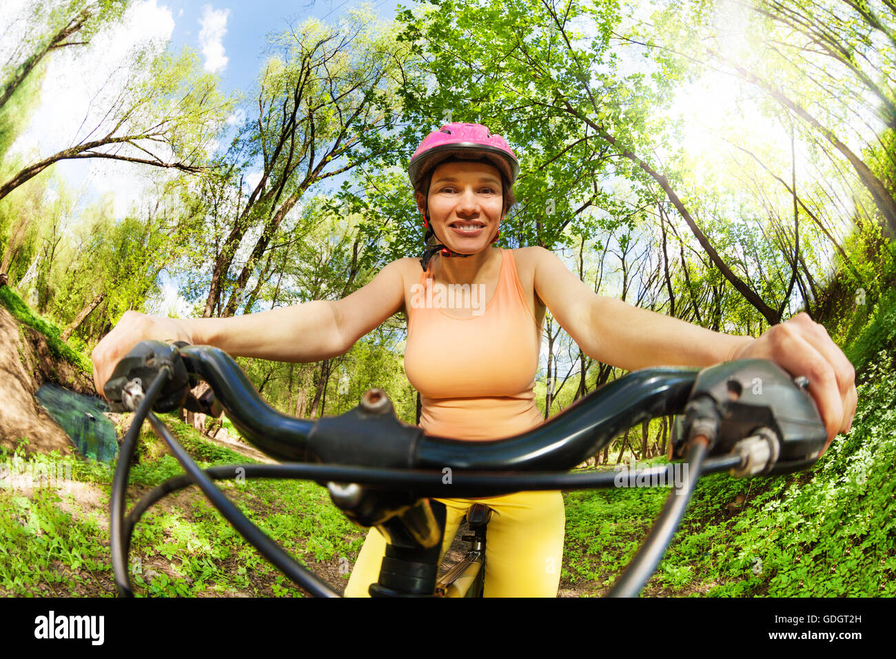 Sporty woman holding on handlebar of her bike Stock Photo - Alamy