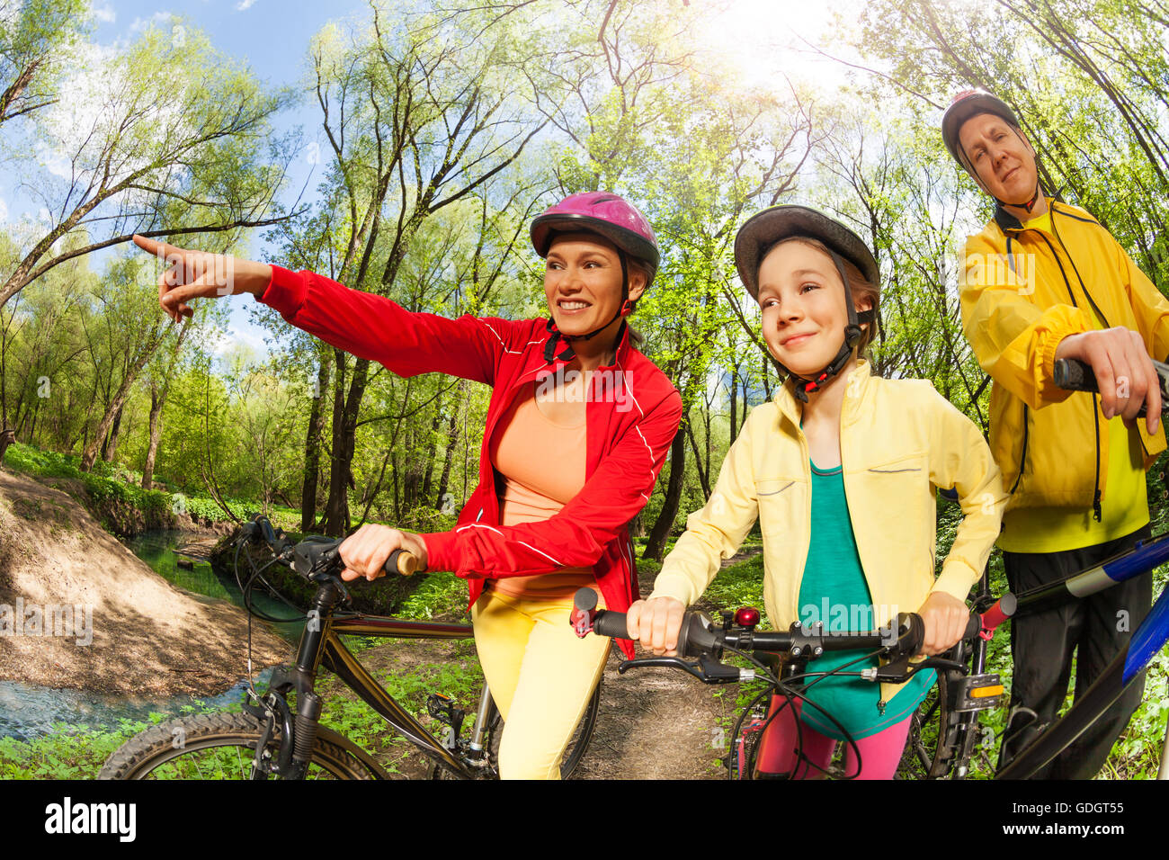 Happy active family with bikes finding their way Stock Photo - Alamy
