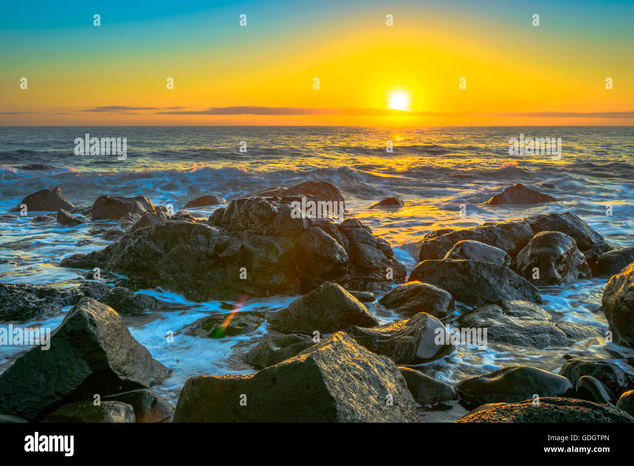 Sunrise over the ocean rocks at Bargara near Bundaberg in Queensland ...
