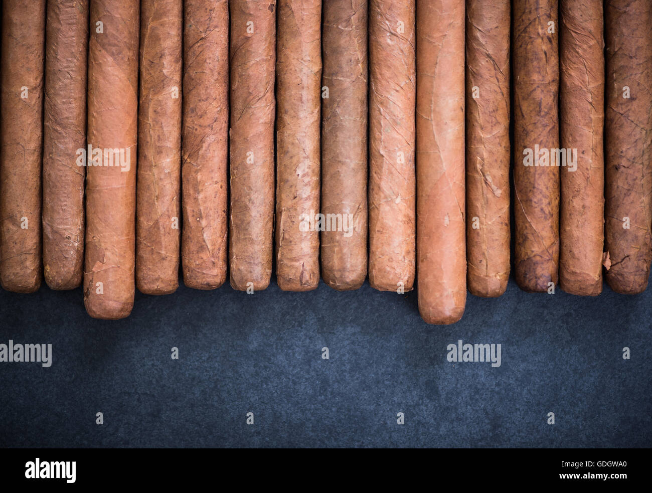 luxury cigars border background on dark slate Stock Photo - Alamy