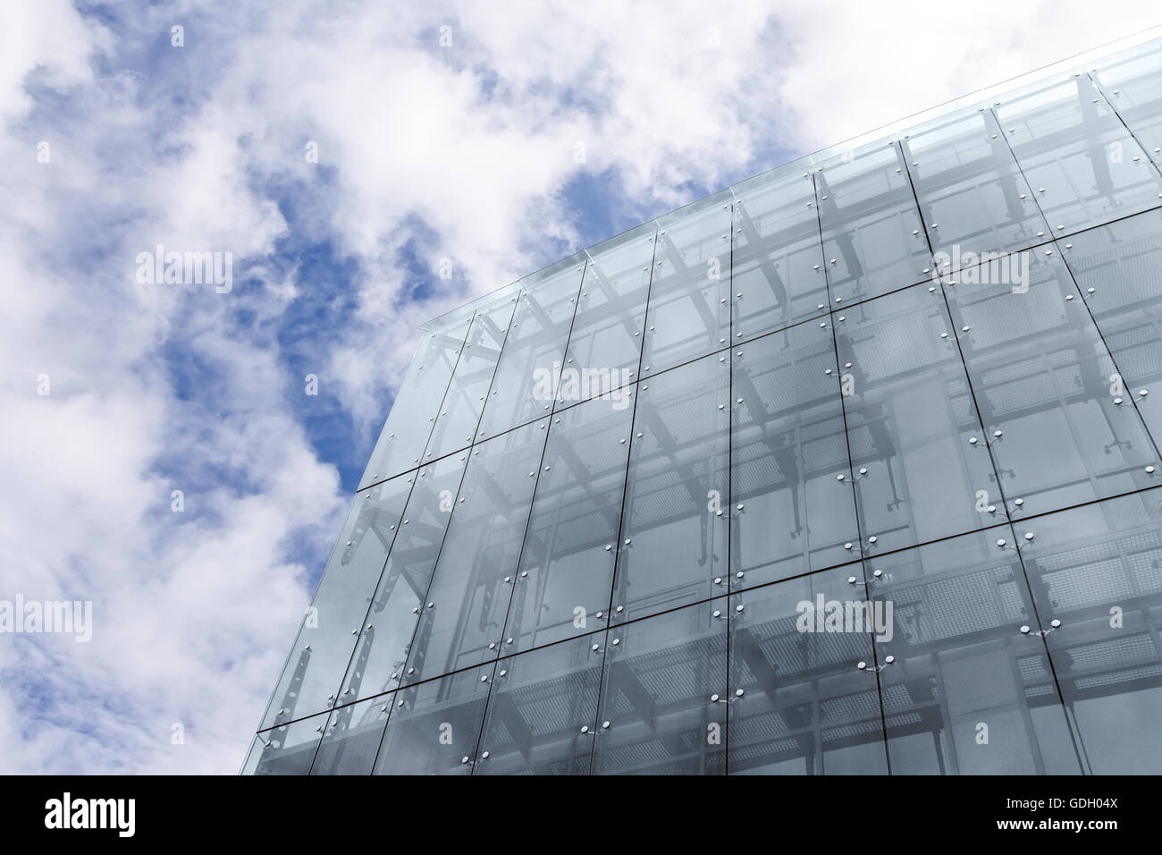 Glass skyscraper against cloudy sky Stock Photo - Alamy