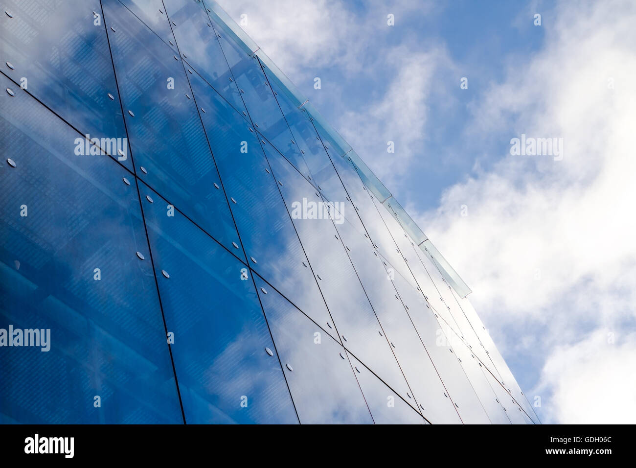Modern glass skyscraper against blue sky Stock Photo - Alamy