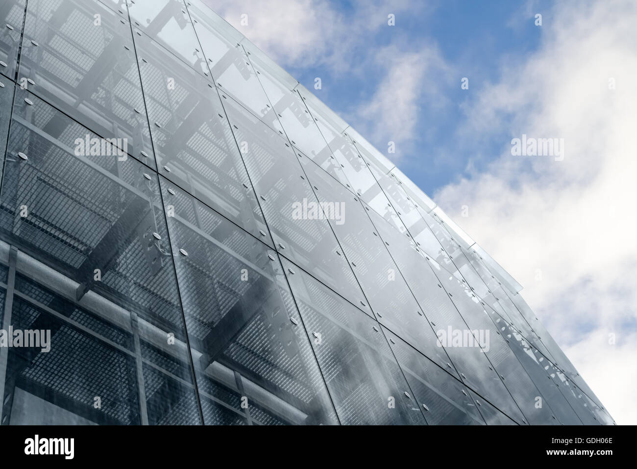 Reflected in glass facade of building Stock Photo - Alamy