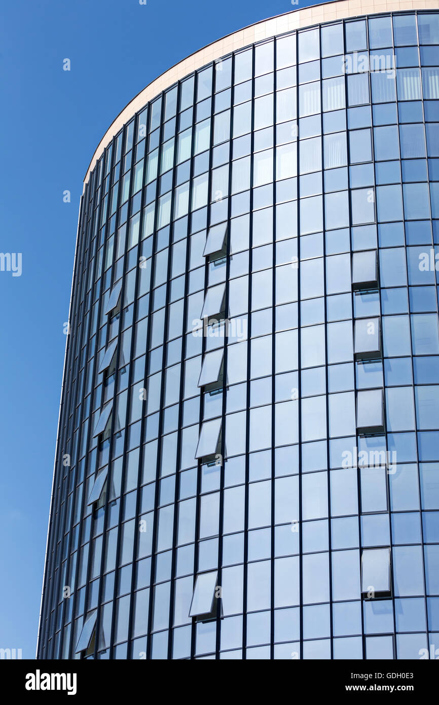 Modern glass building exterior against blue sky Stock Photo - Alamy